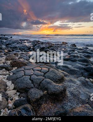 A vertical shot of sunrise over the rocky beach in Oahu, Hawaii Stock ...