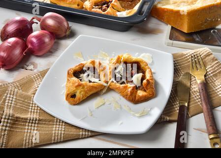 Puff pastry boats with red onions and Parmesan cheese Stock Photo - Alamy