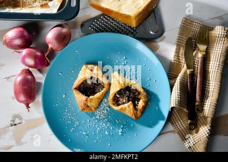 Puff pastry boats with red onions and Parmesan cheese Stock Photo - Alamy