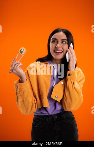 woman holding sushi in chopsticks Stock Photo - Alamy