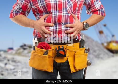 Close-up of male worker grabbing ruler with hands as measurement tool ...