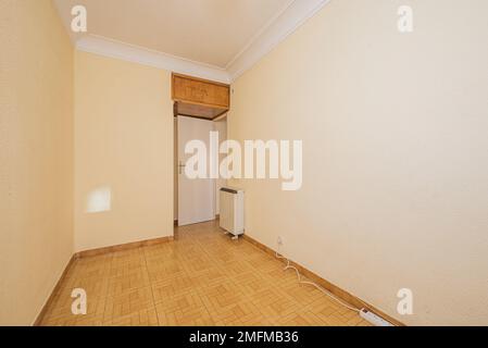 Empty room with plain cream painted wall with tiled floor and single ...