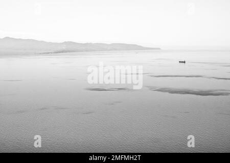 maritime coast of the Tyrrhenian Sea with merchant ship, travel ...
