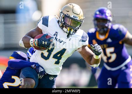 Navy fullback Jamale Carothers (34) runs through the Tulane defense ...