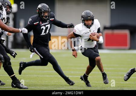 Army quarterback Christian Anderson, right, cuts up field past ...