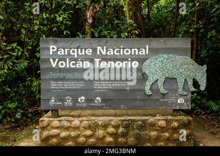 Entrance sign along the trail at the Tenorio Volcano National Park ...