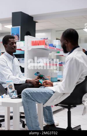 Glucose level measurement in drugstore, african american hands closeup ...