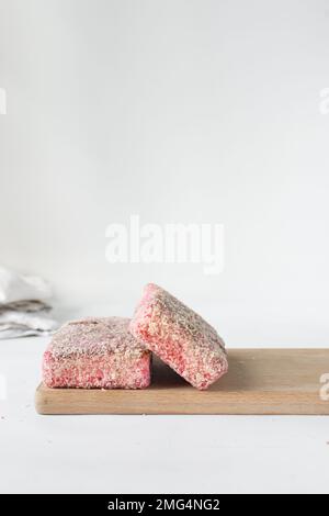 Pink lamingtons on a white background, Australian raspberry lamingtons ...