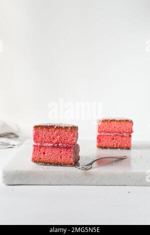 strawberry cakes on a marble tray, pink strawberry cake slices on a ...