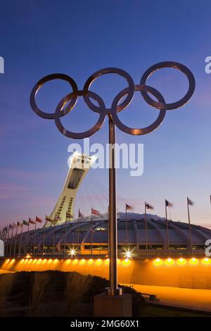 Metal olympic rings sculpture and Olympic Stadium with inclined tower ...