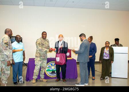 Col. Ivan Udell, left of center, shakes Mr. Angel Diaz hand, who is the ...
