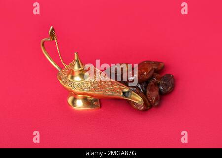 Aladdin lamp of wishes and dates for Ramadan on red background Stock ...
