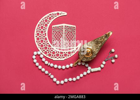 Aladdin lamp of wishes and decorative crescent for Ramadan on table ...