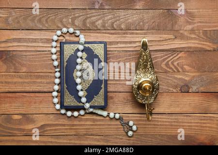 Aladdin lamp of wishes, Koran and prayer beads for Ramadan on dark ...