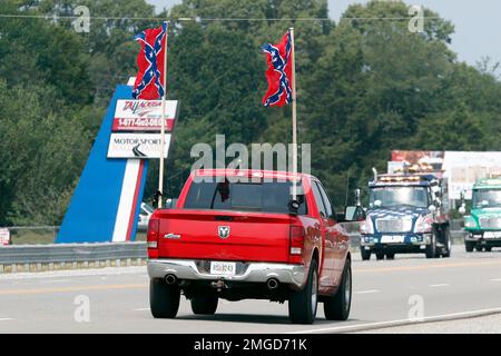A truck flying confederate flags passes the main entrance to Talladega ...