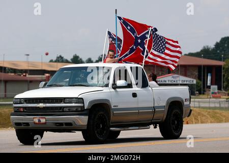 A truck flying confederate flags passes the main entrance to Talladega ...