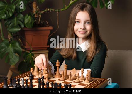 Portrait serious schoolgirl chess player. Female teen posing sitting at ...