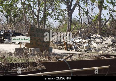 Aftermath - Miscellaneous - 26-HK-46-57. person by tarp on house roof ...