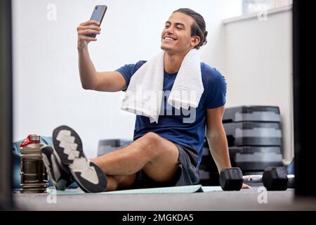 Post workout selfie. a handsome young man taking selfies while ...