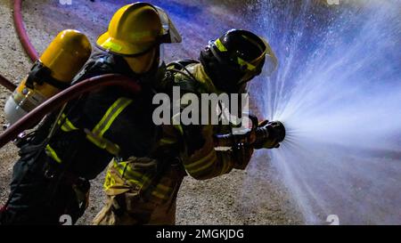 A Royal Saudi Air Force firefighter fits his helmet between two U.S ...