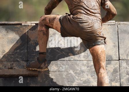Mud race runners view of the participant for overcoming hurdles Stock ...
