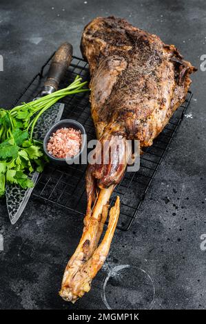 BBQ Roasted lamb mutton leg with herbs and spices on a grill. Isolated ...