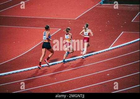 Determined female athletes legs pushing through the long distance race ...