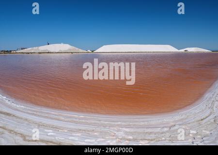 Evaporation basin in the Salins du Midi at Aigues Mortes and piles in ...