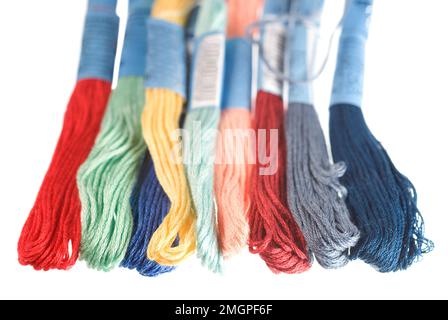 Different color embroidery threads isolated on white Stock Photo - Alamy