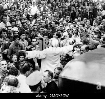 Pope Pius XII open arms standing from his throne blessing the faithfuls ...
