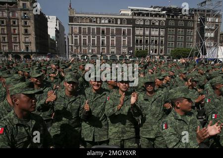 Mexican soldiers cheer during a ceremony to mark Army Day at the Zocalo ...