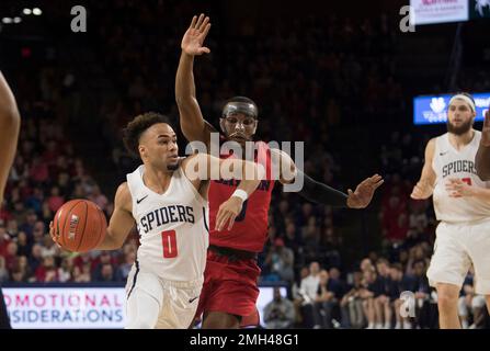 Richmond guard Jacob Gilyard (0) drives around Dayton defender Jalen ...