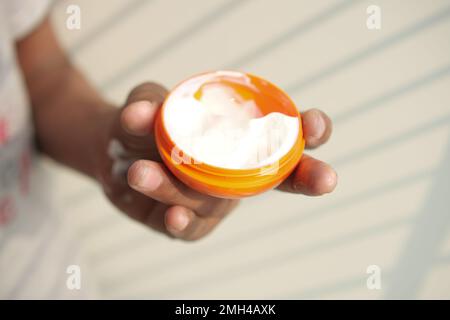 man applying beauty cream onto skin Stock Photo - Alamy