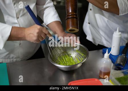 Cook mixing eggs and agar agar. whisk eggs Stock Photo - Alamy