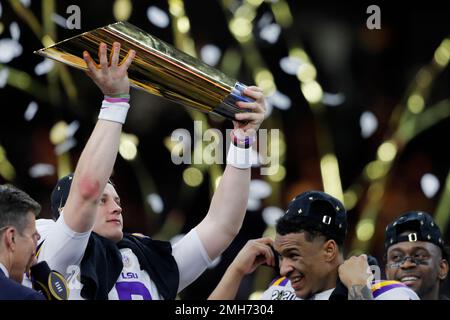 LSU safety Grant Delpit holds the trophy as quarterback Joe Burrow ...