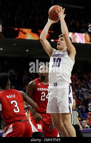 Northwestern forward Miller Kopp (10) and forward Pete Nance (22) celebrate their win against ...