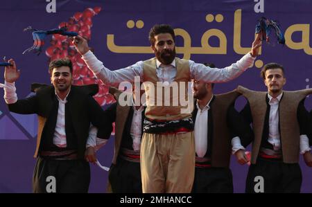 Iranian Kurd performers in traditional attire dance a traditional ...