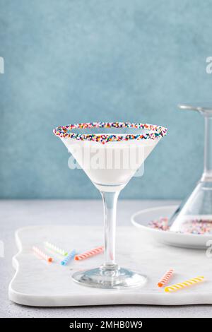 Birthday cake martini with sprinkles on the glass rim topped with ...