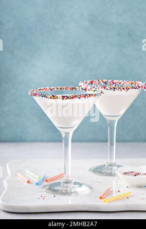 Birthday cake martini with sprinkles on the glass rim topped with ...