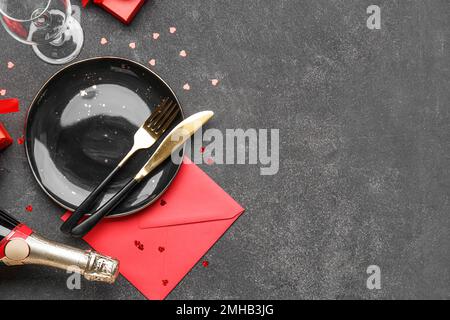 Table setting for Valentine's Day with envelope and gift on beige ...