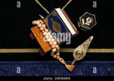 Aladdin lamp, Muslim lantern, Koran and prayer beads for Ramadan on mat ...