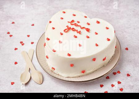 Plate with heart-shaped bento cake on white background. Valentine's Day ...