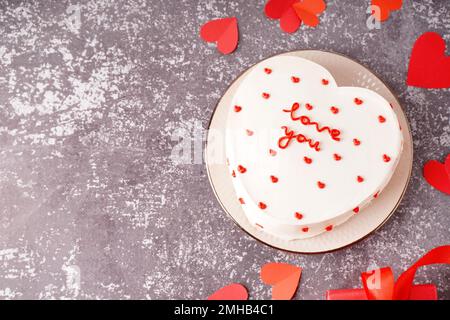 Plate with heart-shaped bento cake on grey background. Valentine's Day ...