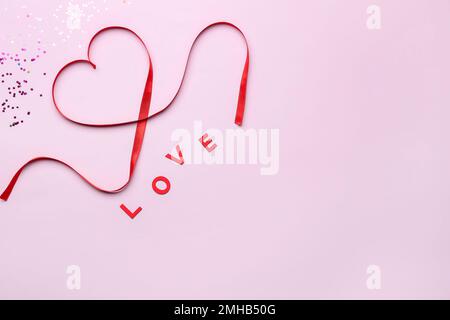 Sequins and heart made of red satin ribbon on green background ...