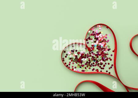 Heart made of sequins on a green table. Copy space Stock Photo - Alamy