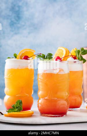 Zombie tropical cocktail with rum in tiki glasses Stock Photo - Alamy