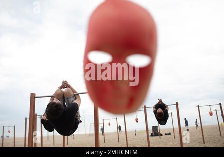 Demonstrators perform as victims in a torture device, called pau-de ...