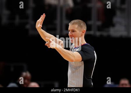 Referee Tyler Ford signals during the second half of an NBA basketball ...