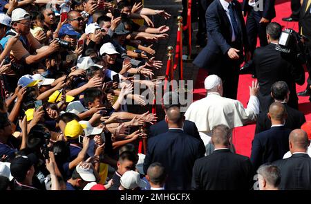 Priests reach out to touch Pope Benedict XVI as he leaves the altar at ...