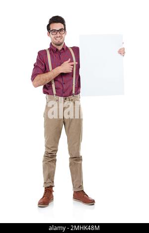 Young man pointing at blank paper sign on lilac background Stock Photo ...